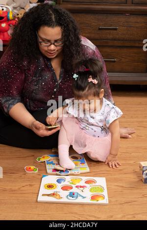 hispanic baby girl playing with her mother in the park Stock Photo - Alamy