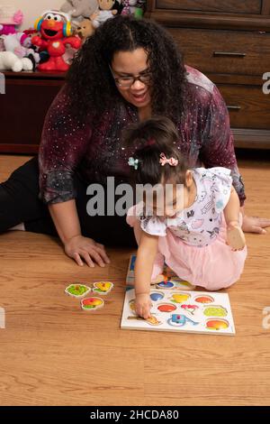 hispanic baby girl playing with her mother in the park Stock Photo - Alamy