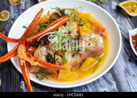 Steamed red snapper fish with ingredients including fish, pineapple ...
