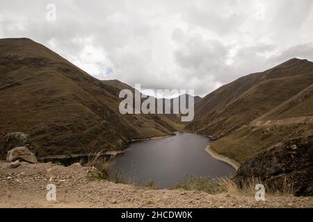 Small dark lake surrounded by mountains and hills in Peru Stock Photo ...