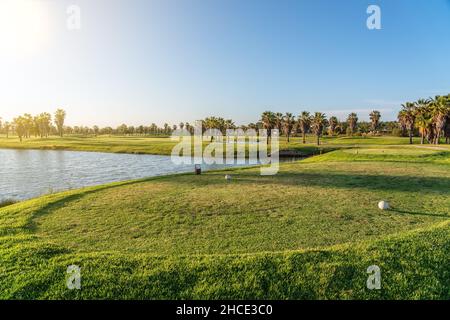 Modern golf courses for tourists with clear ponds and palm trees for ...