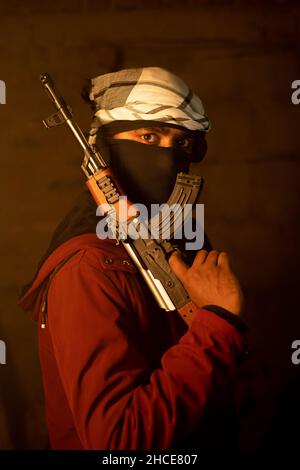 Side view of anonymous soldier in military clothes standing near white ...