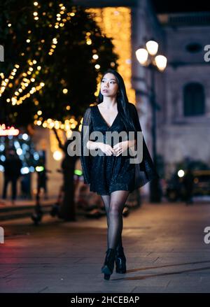 Asian fashionable woman walking at shopping mall with shopping bags ...