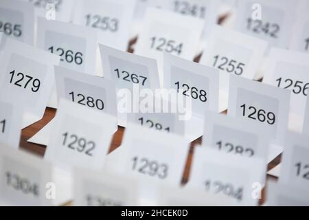 Different numbers printed on sheets of papers organized in a row Stock ...