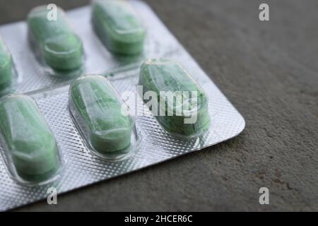 Crushed and damaged tablets in closeup view. Concept of expired drugs ...