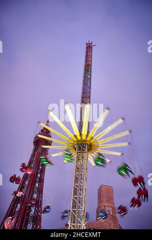 The Star Flyer ride and Blackpool Tower at dusk Stock Photo - Alamy