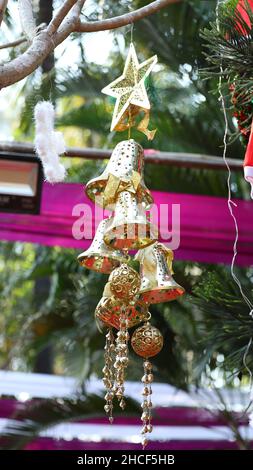 Beautiful gold ornament hanging on a lighted Christmas tree Stock Photo ...
