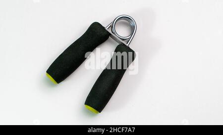 Closeup shot of a hand exercise clamp isolated on a white background ...
