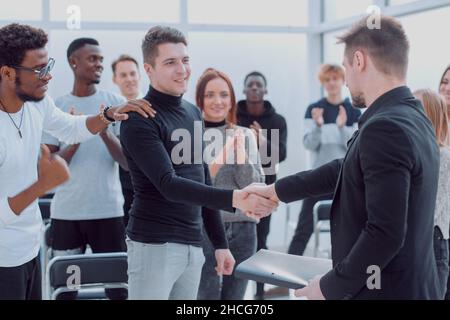 speaker welcoming a new participant of the seminar Stock Photo - Alamy