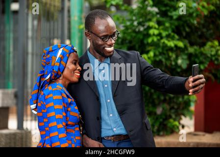 two adult partners rejoicing while taking photo together on mobile ...