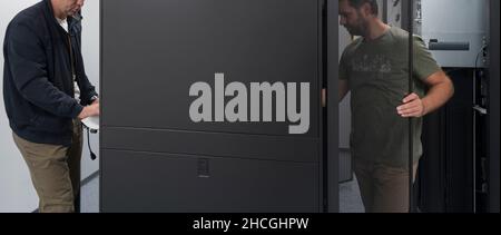 Technicians team updating hardware inspecting system performance in ...