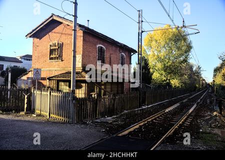 Old brick building by the edge of a railroad crossing at sunset Stock ...