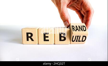 Rebrand and rebuild symbol. Businessman turnsa wooden cubes and changes ...