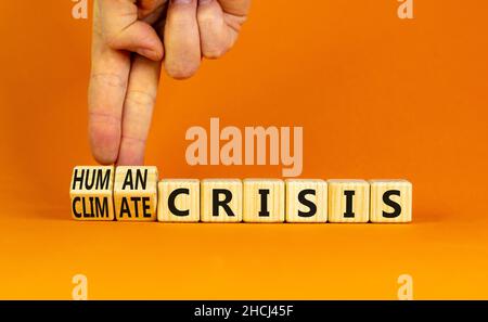 Climate or human crisis symbol. Businessman turns wooden cubes and ...