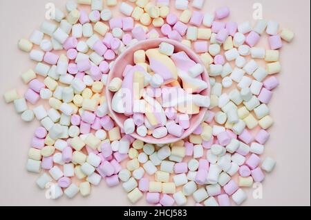 Closeup of colorful mini marshmallows with candy in bowl on wooden ...
