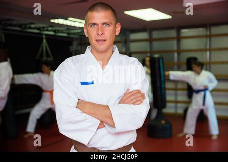 Karate trainer standing in gym Stock Photo - Alamy
