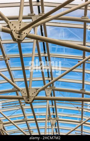 Low angle shot of a metal and glass geometrical structure under the ...