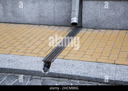 Metal grating for rainwater drainage on asphalt road surface on ...