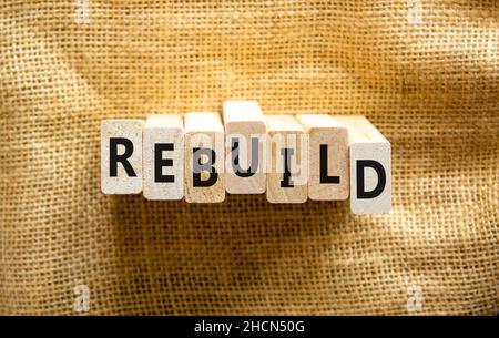 Rebuild and build symbol. The concept word Rebuild on wooden circles ...