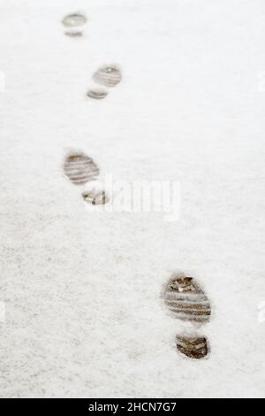 Frozen Footsteps on Snowy Sidewalk Stock Photo - Alamy