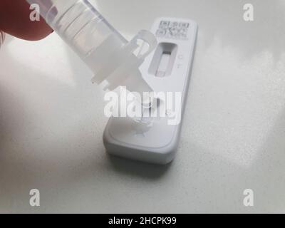 London, UK, 31 December 2021: a person drops buffer solution containing ...