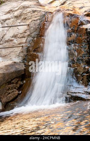 A vertical shot of a waterfall over the rocks Stock Photo - Alamy