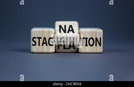 Stagflation or stagnation symbol. Businessman turns cubes, changes the ...