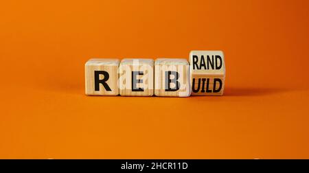 Rebuild and Rebrand symbol. Turned wooden cubes with words Rebrand and ...