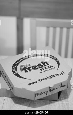Grayscale of boxes of Fresh Pizza company on a wooden table Stock Photo ...