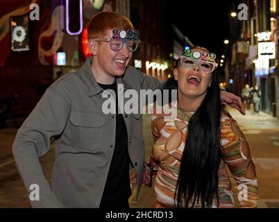 Revellers during New Year's Eve celebrations in Liverpool. Picture date ...
