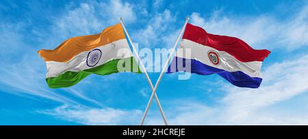 crossed national flags of India and Paraguay flag waving in the wind at ...
