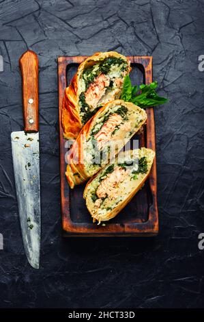 Appetizing fish pie made from salmon fish, rice and spinach. Red fish ...