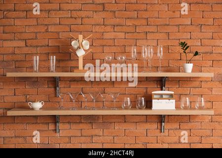 Empty shelves hanging on brick wall Stock Photo - Alamy