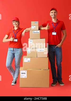 Young woman with parcels showing thumb-up at home Stock Photo - Alamy