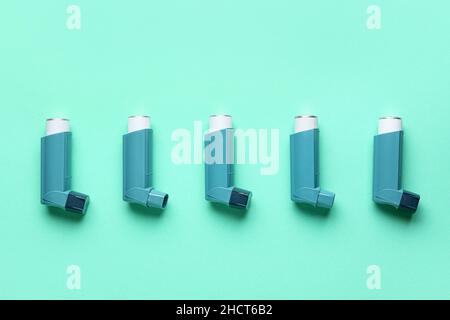 Asthma inhalers on green background, closeup Stock Photo - Alamy
