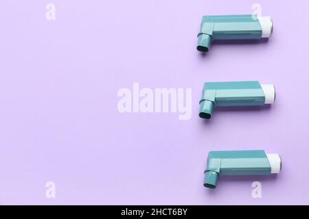Modern asthma inhalers on color background Stock Photo - Alamy