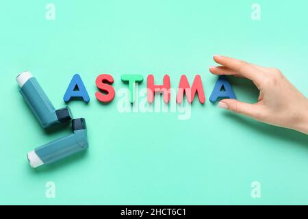 Female hand and word ASTHMA color background Stock Photo - Alamy
