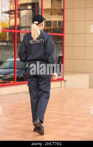 Female security guard outdoors, back view Stock Photo - Alamy