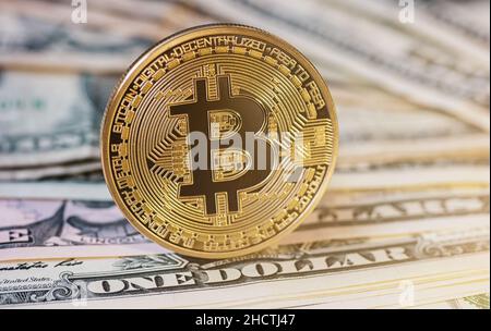 Golden Bitcoin on US dollar bills. Electronic money exchange concept ...