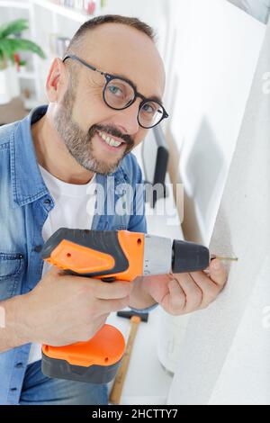 portrait of young hardworking man with drill Stock Photo - Alamy