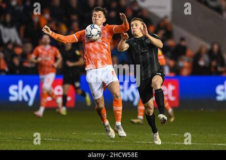 Ryan Wintle #8 of Blackpool controls the ball ahead of Greg Docherty #8 ...
