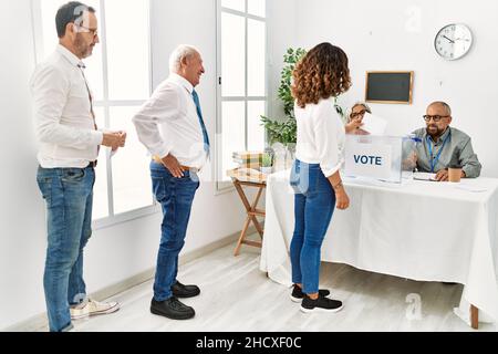 Group of middle age voter people putting vote in ballot standing at ...