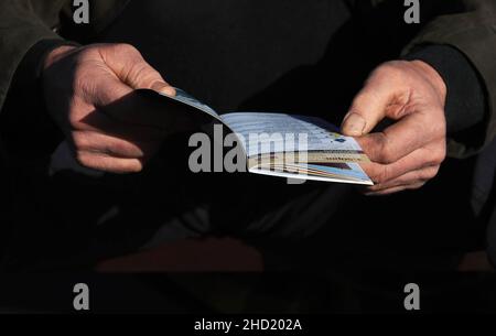 A racegoer checks his race card at Naas racecourse. Picture date ...
