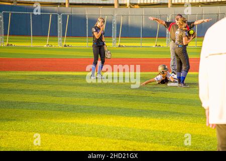 Closeup shot of females playing softball in the field in Mason in the ...