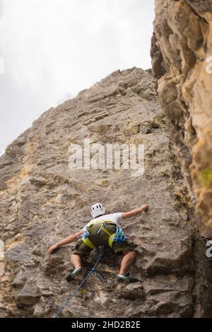 Handsome rock climber preparing for training. Shallow depth of field ...