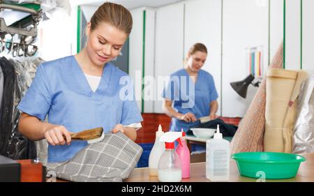 Portrait of skilled female laundry worker during daily work Stock Photo ...