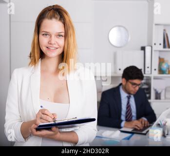 Secretary writing boss instructions Stock Photo - Alamy