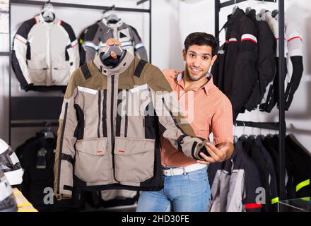 Man is demonstrating new jacket for motorbike in the store Stock Photo ...