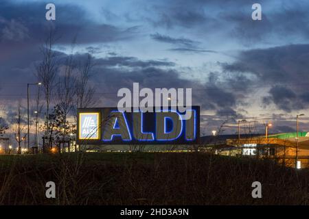 Store logo at night for ALDI supermarket England UK Stock Photo - Alamy