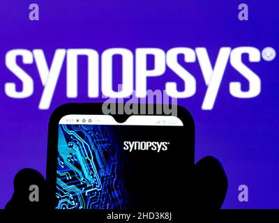 In this photo illustration a Synopsys logo seen displayed on a ...